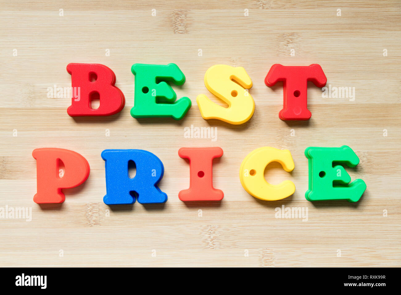 Color plastic alphabet in word best price on wood background Stock ...