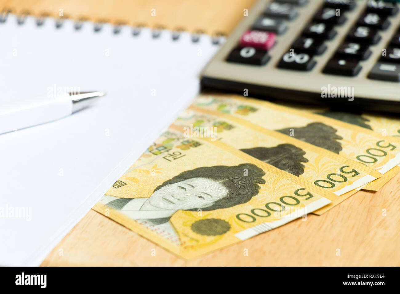 Blank note book with pen, calculator and south korea won (krw) banknote ...