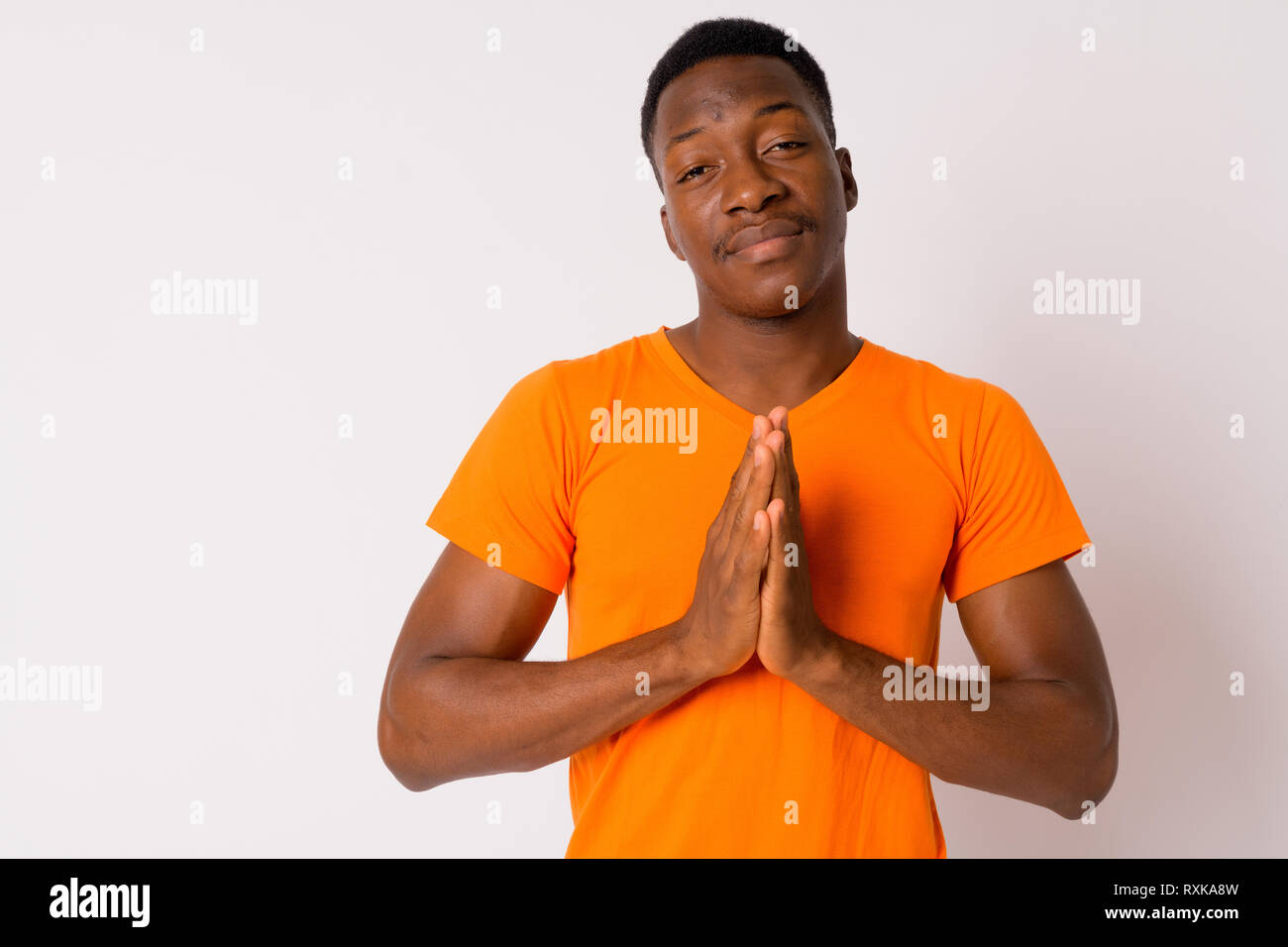 Portrait of young African man begging with hands together Stock Photo ...