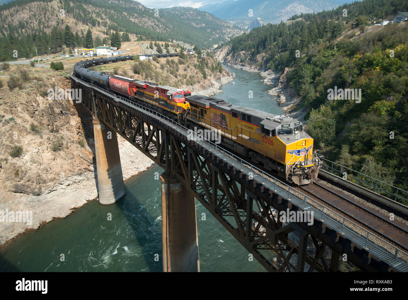 A mixed freight train crosses the thompson river in lytton hi-res stock ...