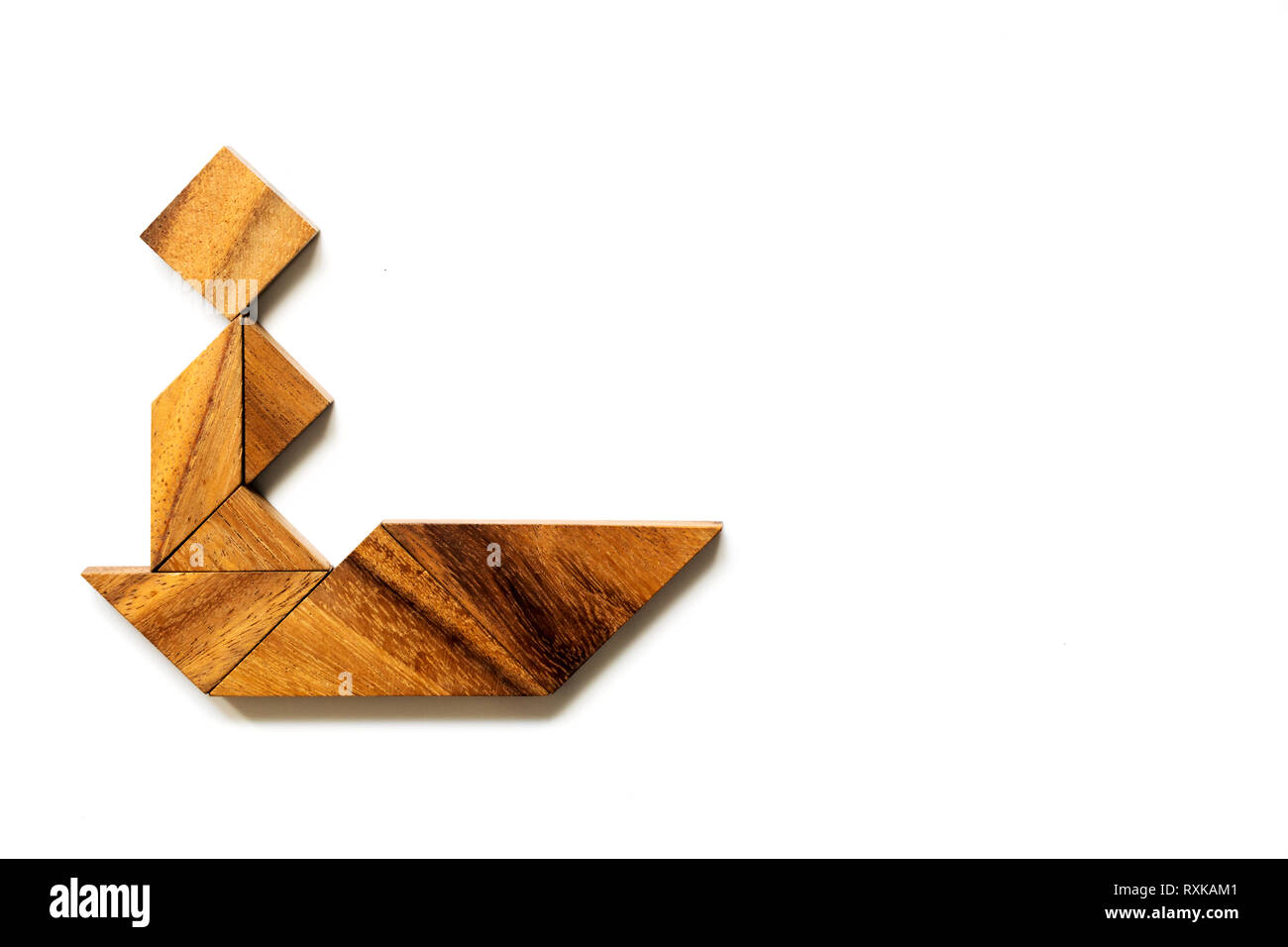Wood tangram puzzle in boat with man shape on white background Stock ...