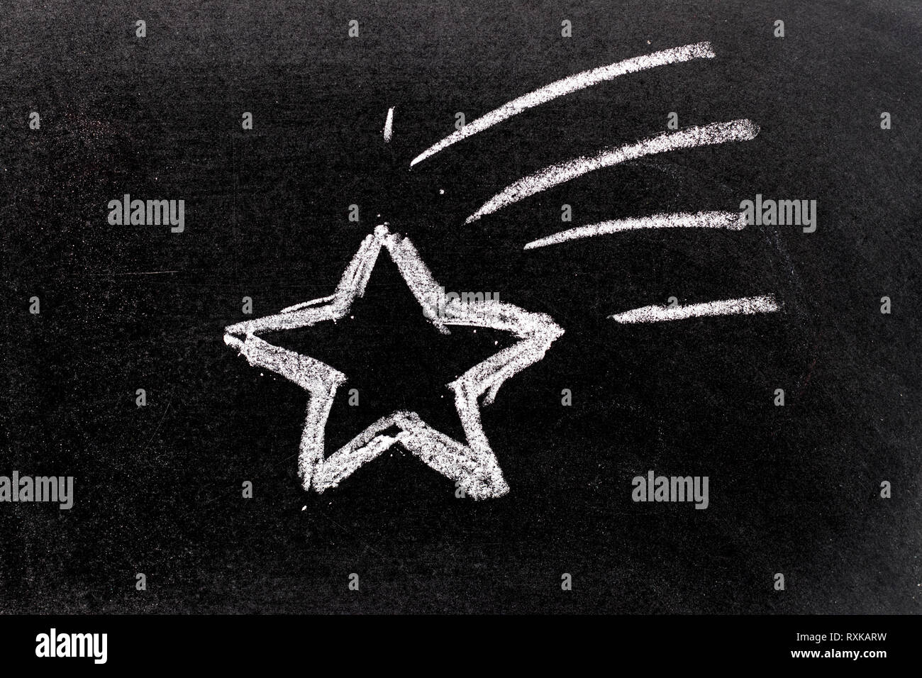 White color chalk hand drawing in star fall shape on blackboard ...