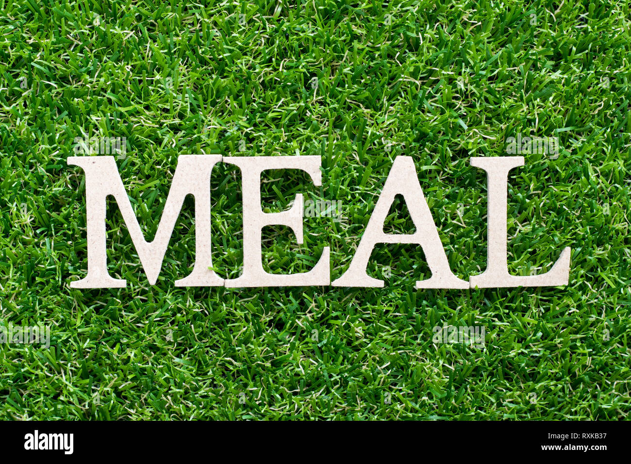 Wood alphabet in word meal on artificial green grass background Stock ...