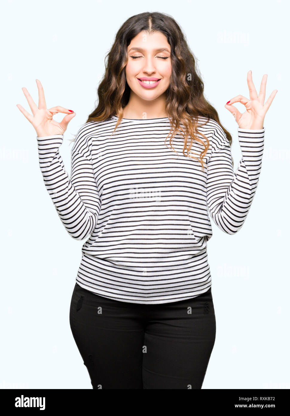 Young beautiful woman wearing stripes sweater relax and smiling with ...
