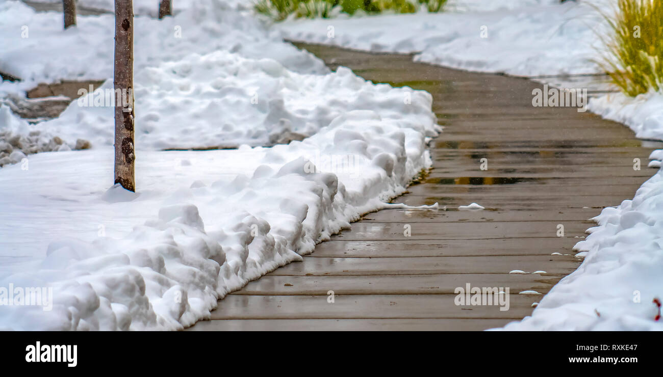 Wet wooden pathway amid snow in Daybreak Utah Stock Photo - Alamy