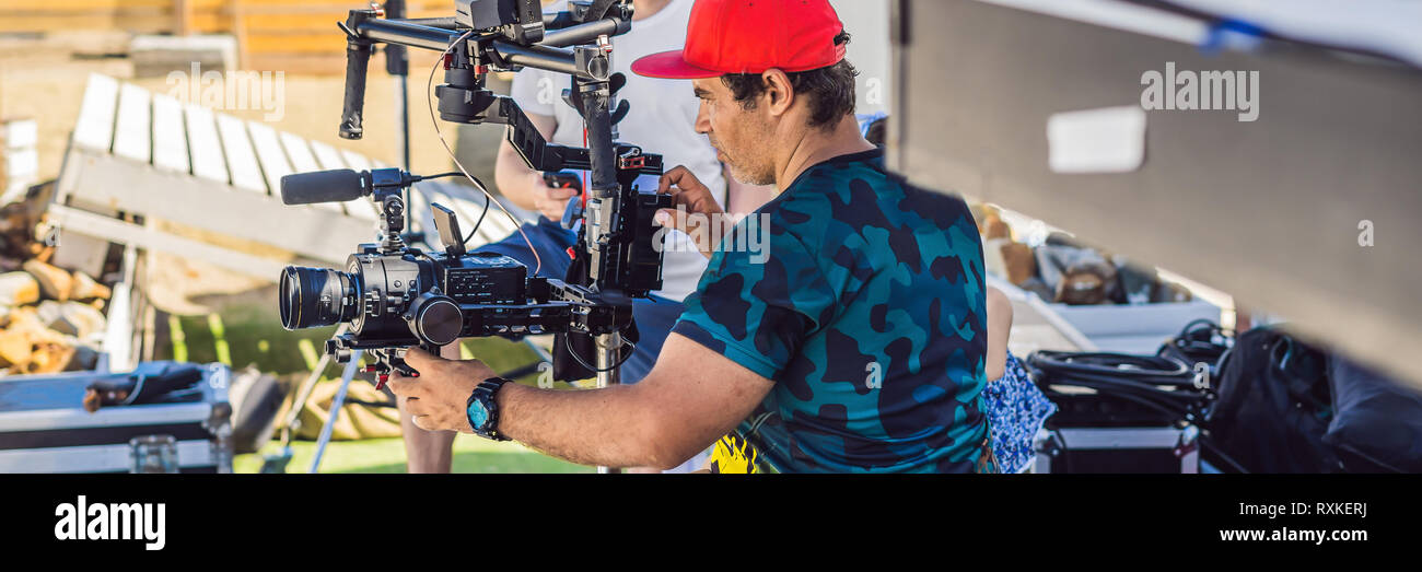 Steadicam operator and his assistant prepare camera and 3-axis ...
