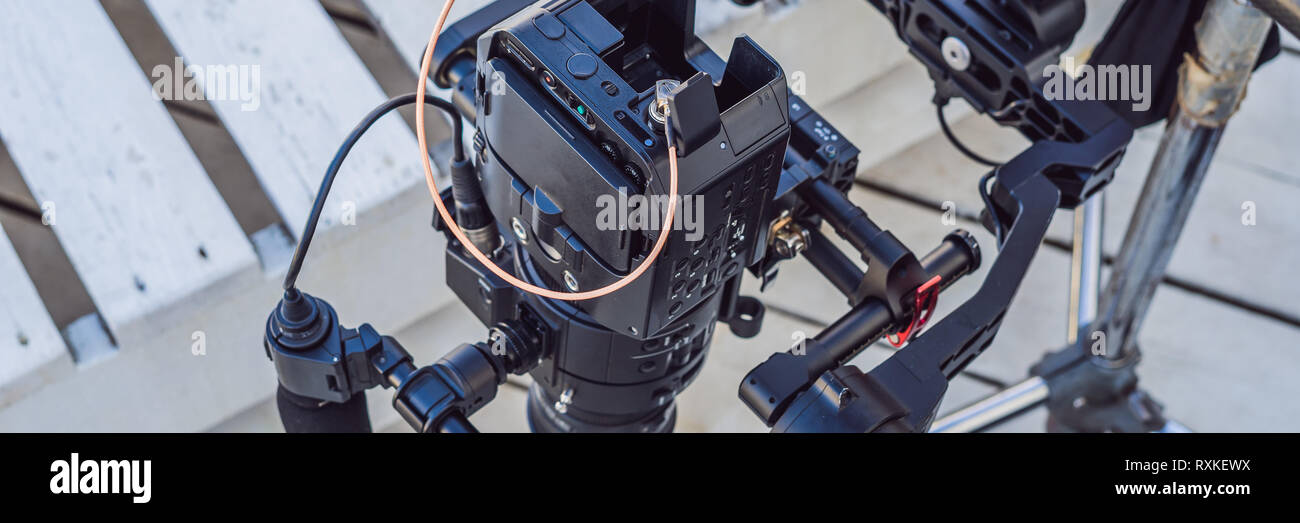 Steadicam operator and his assistant prepare camera and 3-axis ...