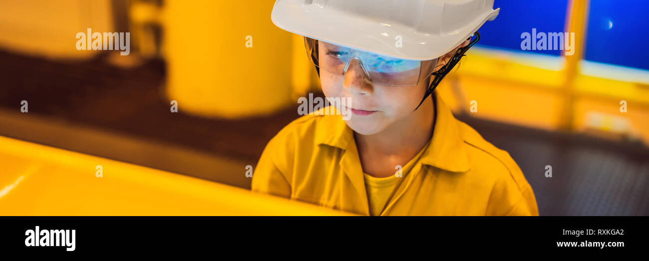 Boy operator recording operation of oil and gas process at oil and rig ...