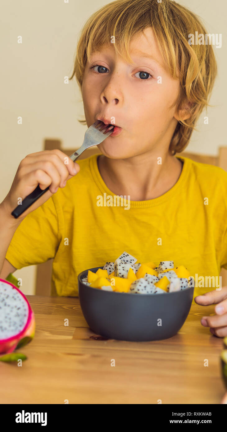 Boy eats fruit. Healthy food for children. Child eating healthy snack ...