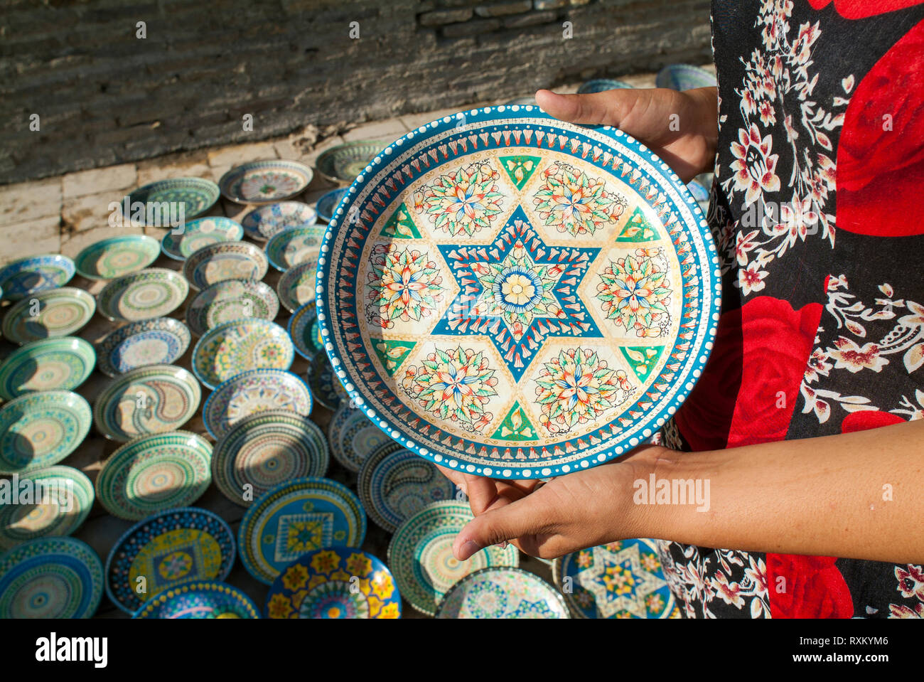 Traditional painted plates for sale in the old city of Bukhara. The ...