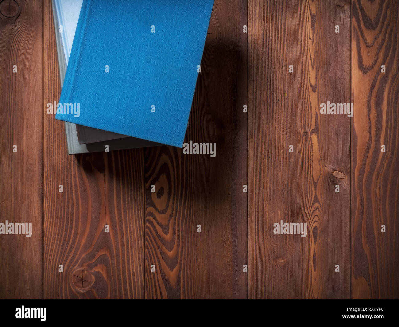 Top view on the pile of books lying on the table Stock Photo - Alamy