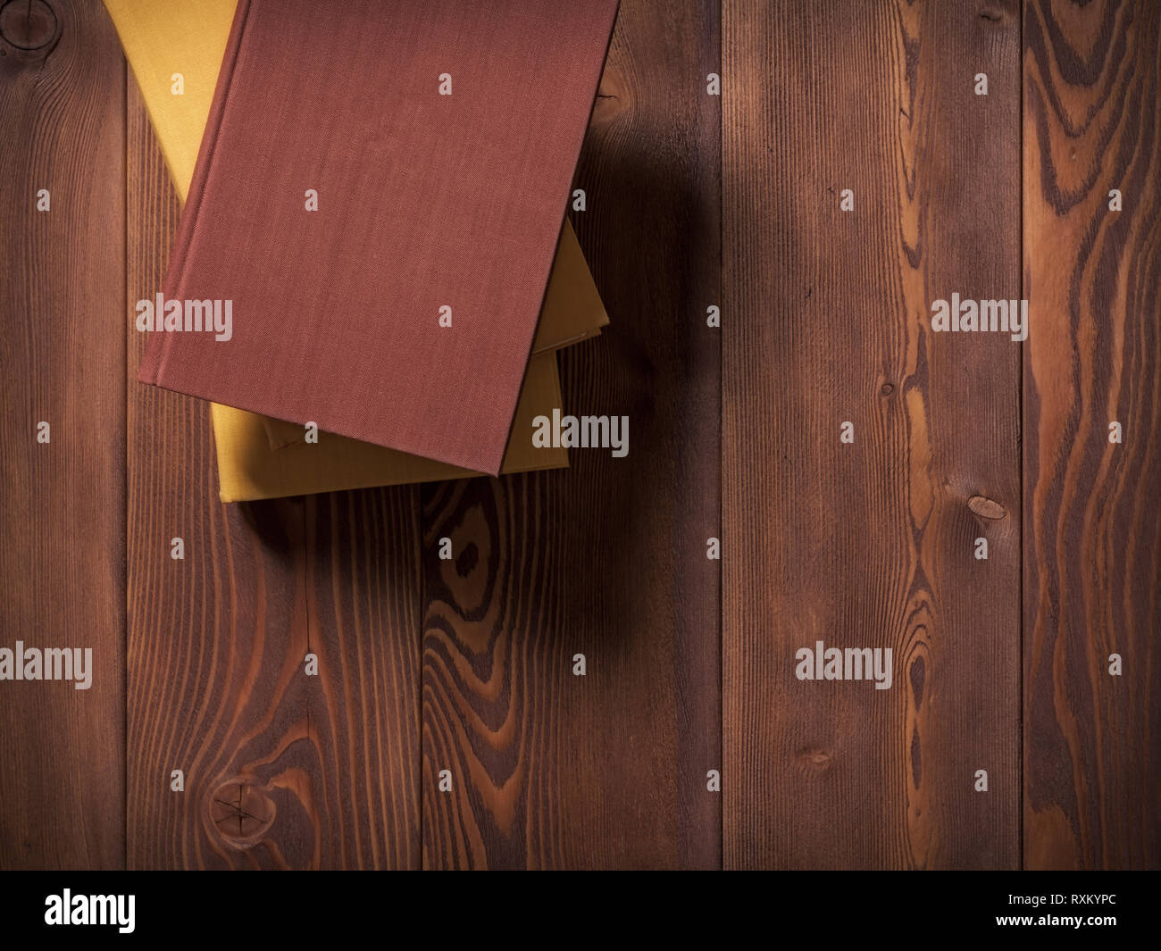Top view on the pile of books lying on the table Stock Photo - Alamy
