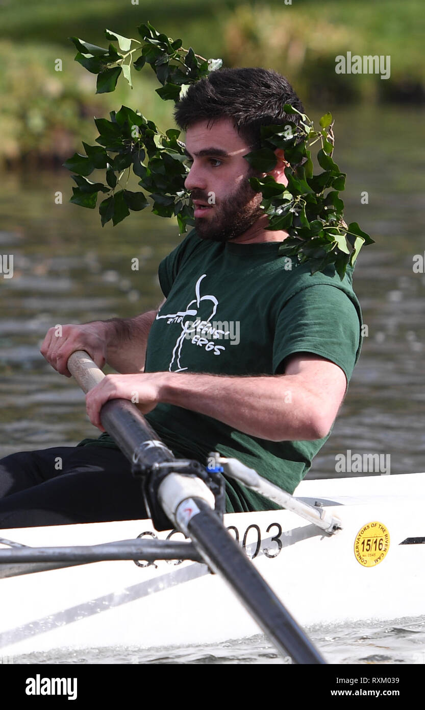 A crew member from Queens' College wears greenery in his hair to ...