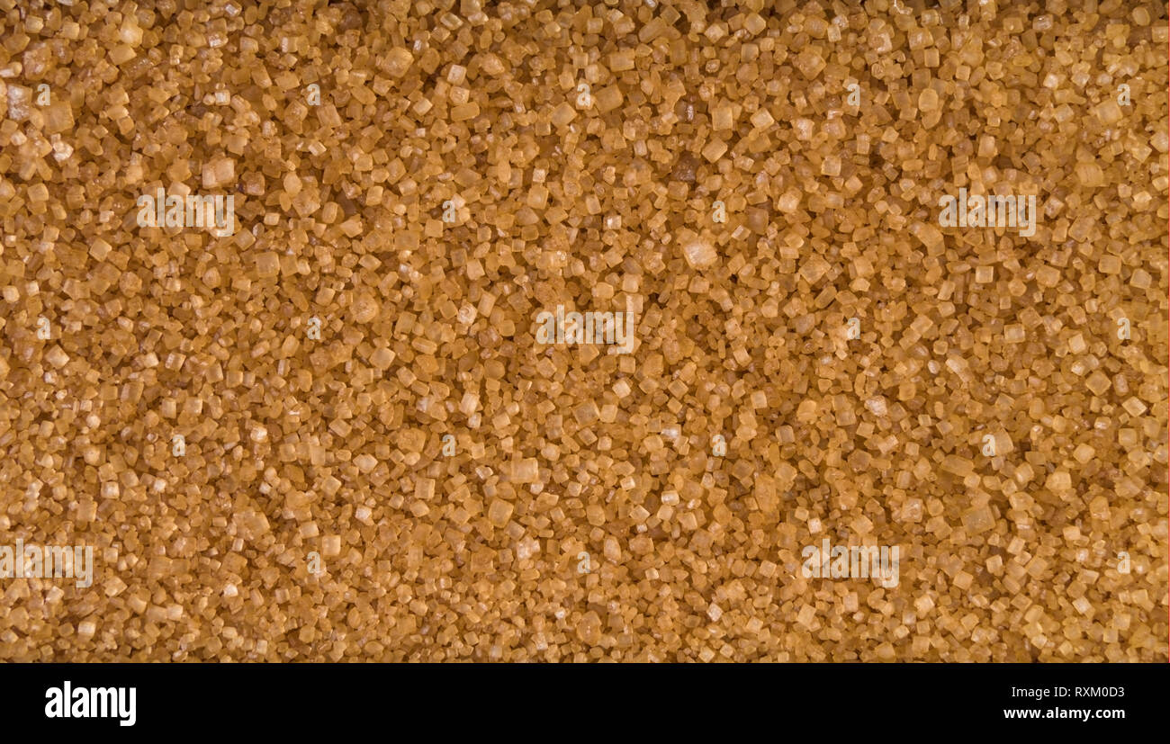 Brown or cane sugar background. Natural seasoning texture. Natural ...