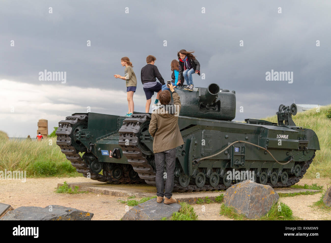 Children climbing on a AVRE Churchill tank memorial close to Juno Beach ...
