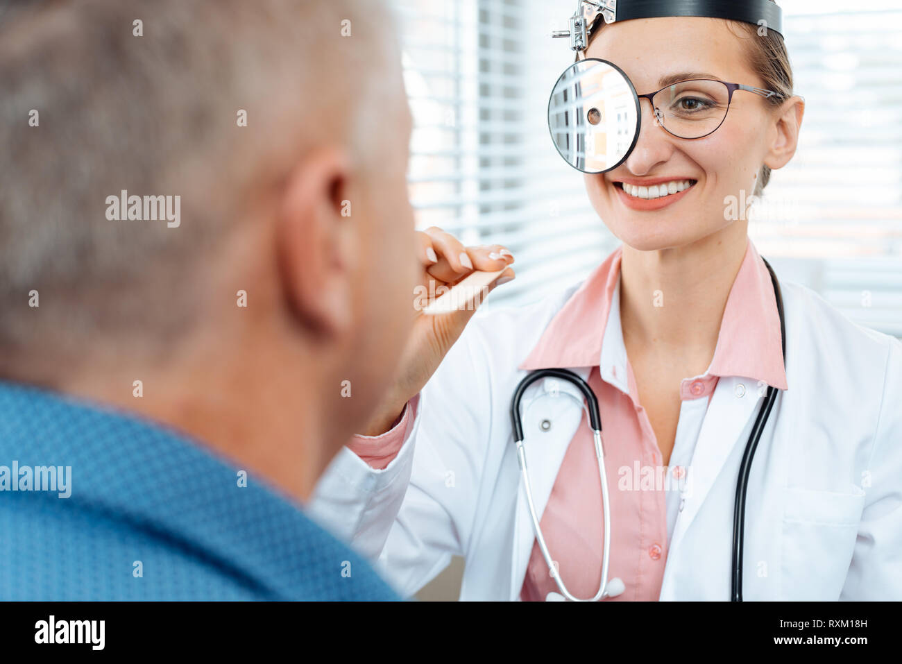 ENT doctor examining patient Stock Photo - Alamy