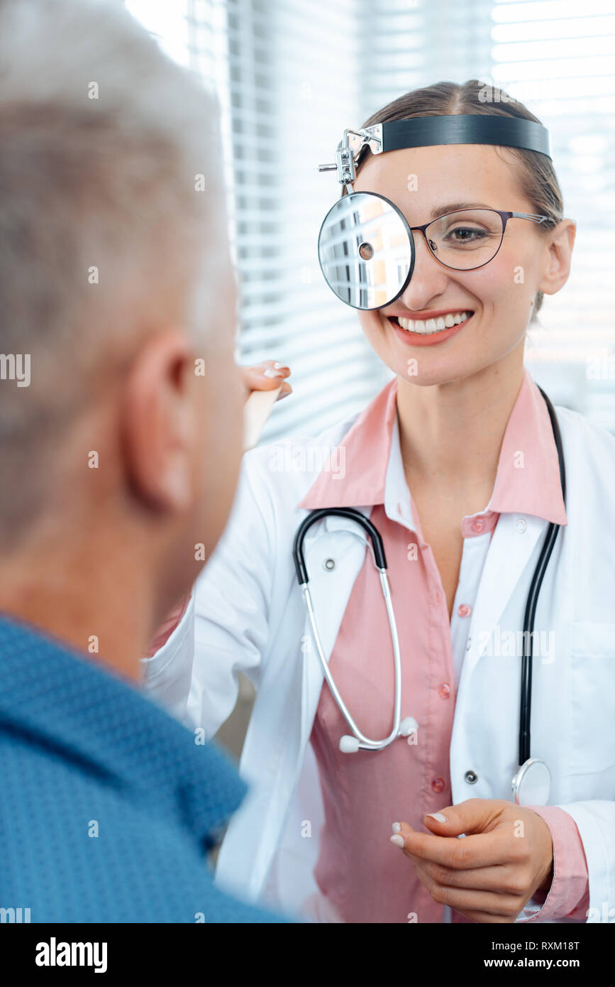 ENT doctor examining patient Stock Photo - Alamy