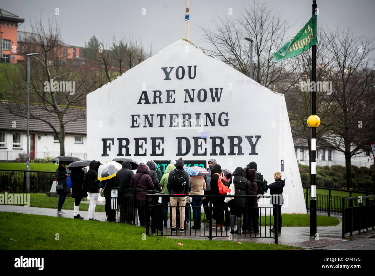 Tourists are show Free Derry Corner as part of a guided tour of Derry's ...
