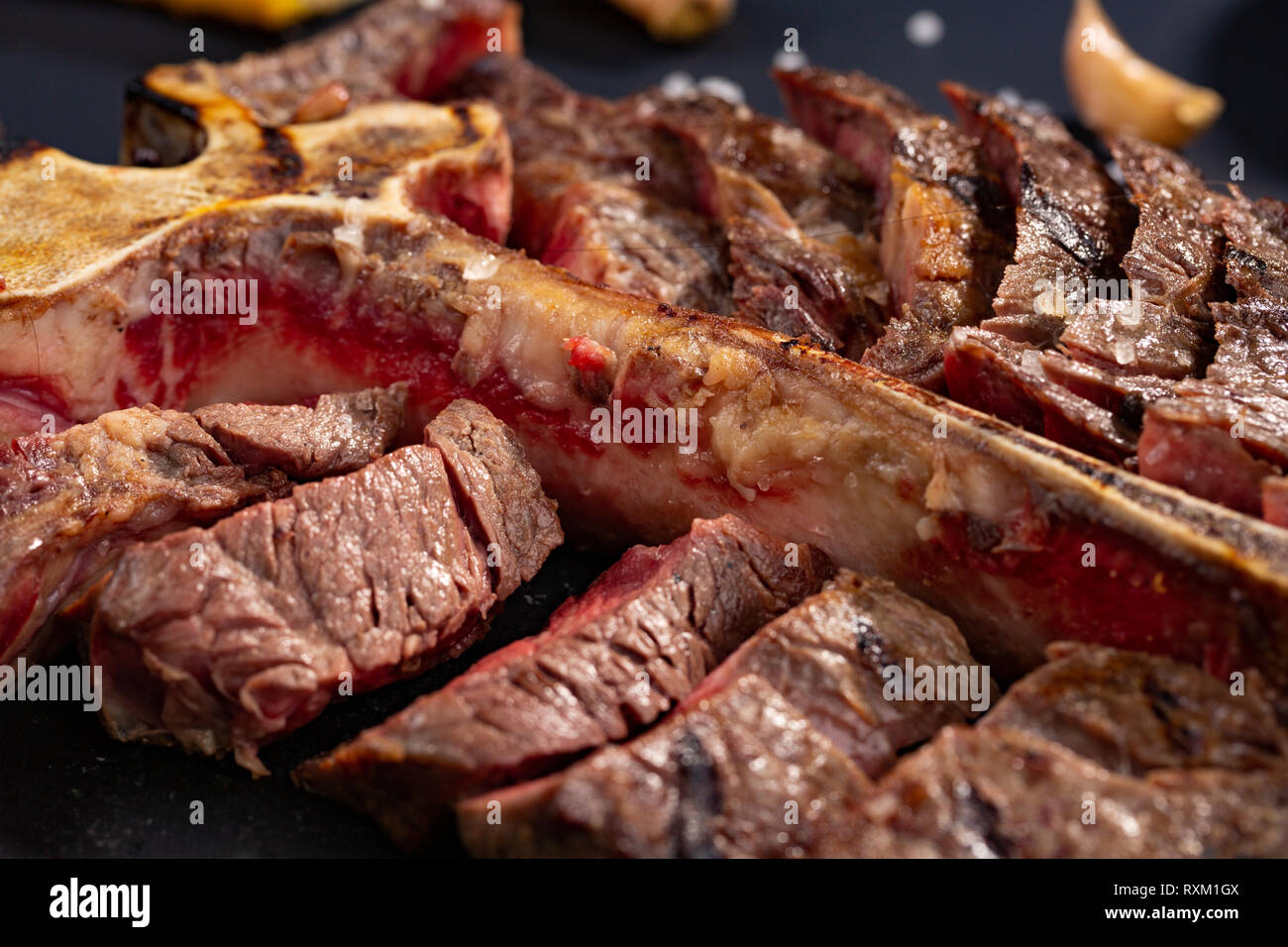 porterhouse steak is grilled sliced on a piece of wood Board. rustic ...