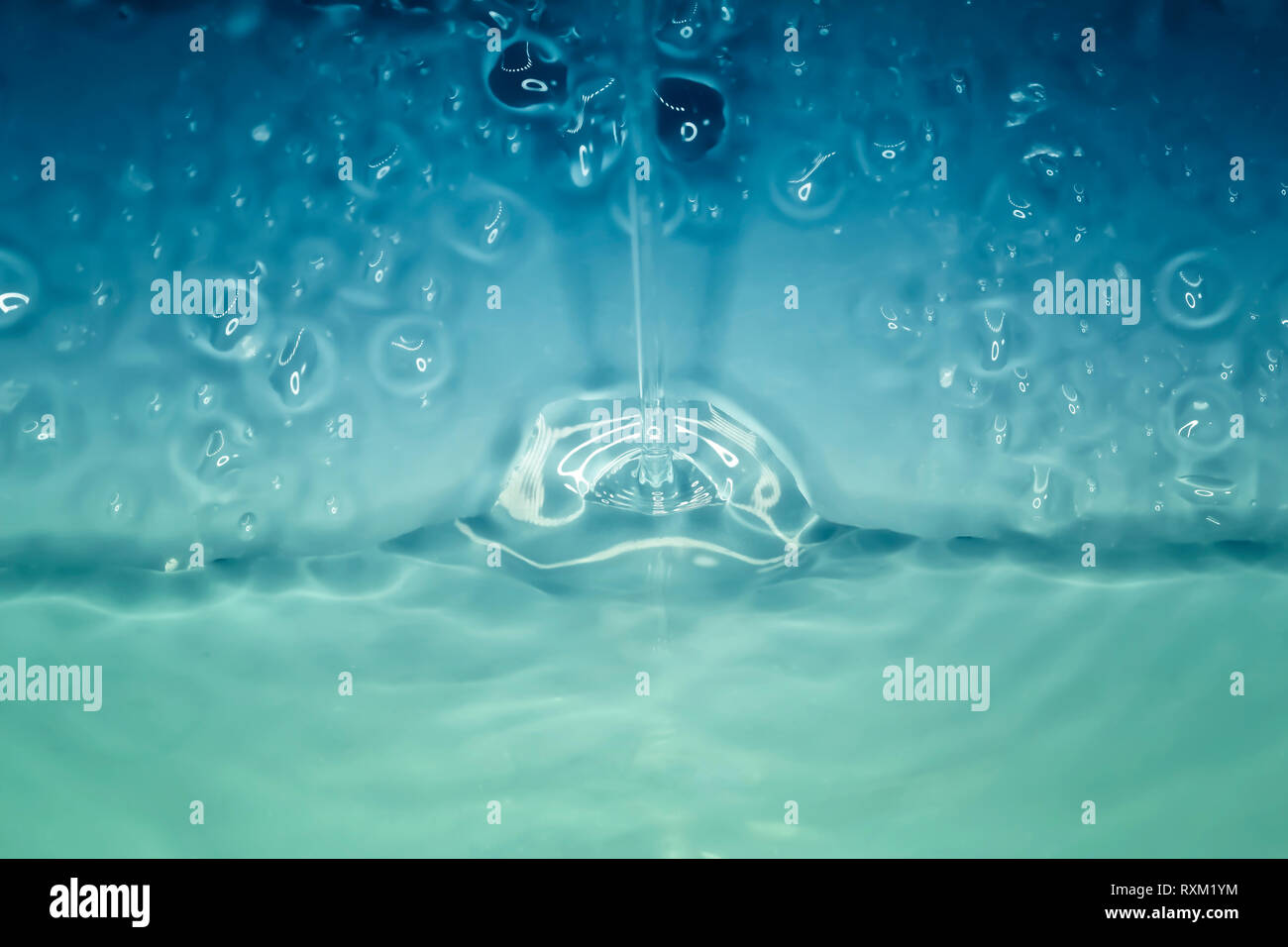 Water jet on blue background Stock Photo - Alamy
