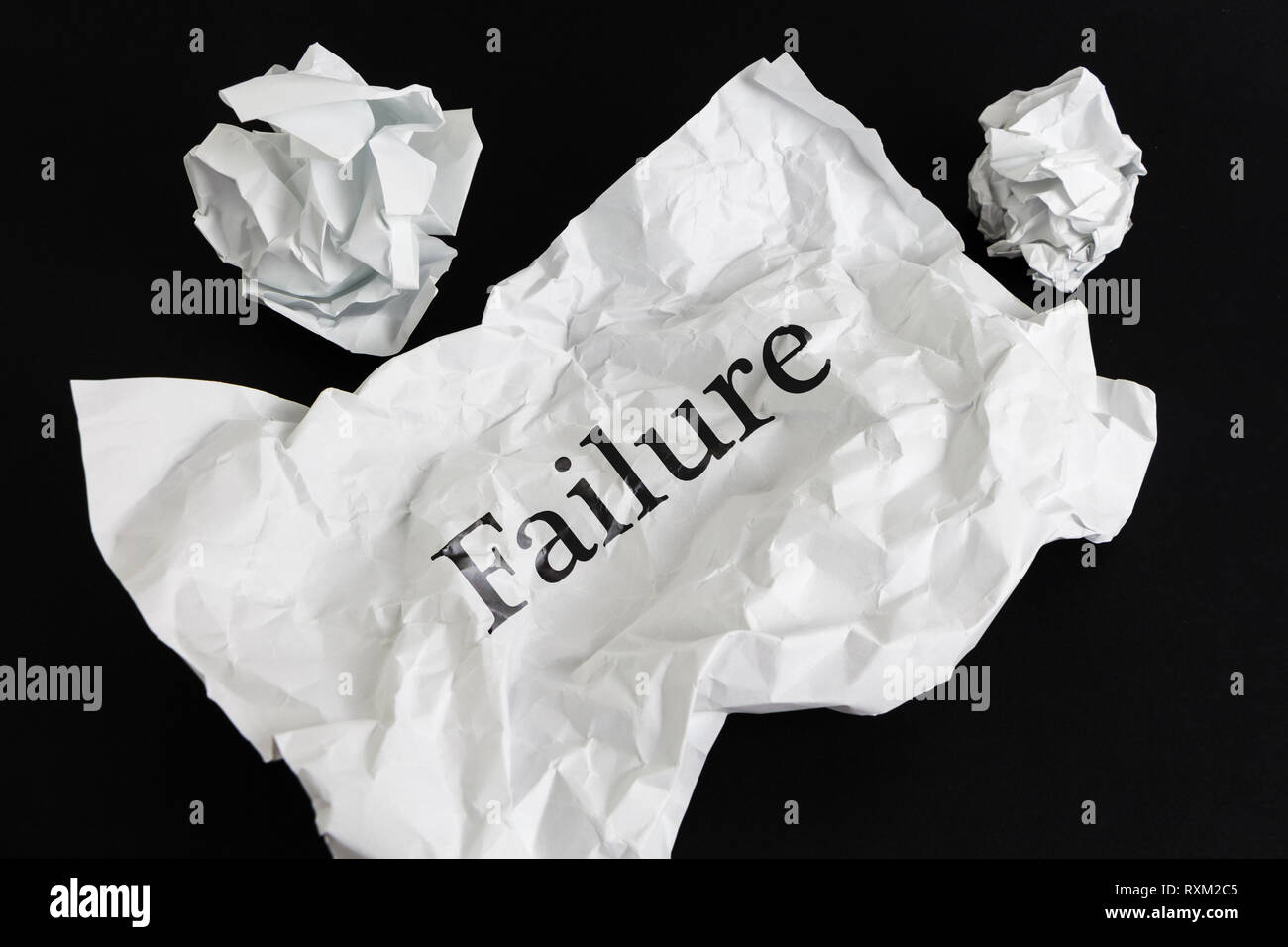 Crumpled paper sheet with word Failure isolated on black Stock Photo ...