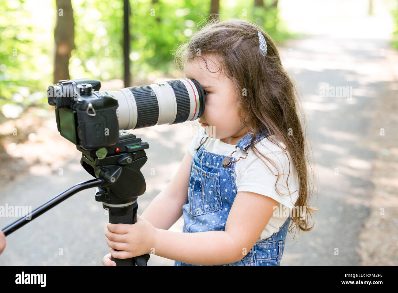 Hobby, children and photographer concept - child with camera in forest Stock Photo - Alamy