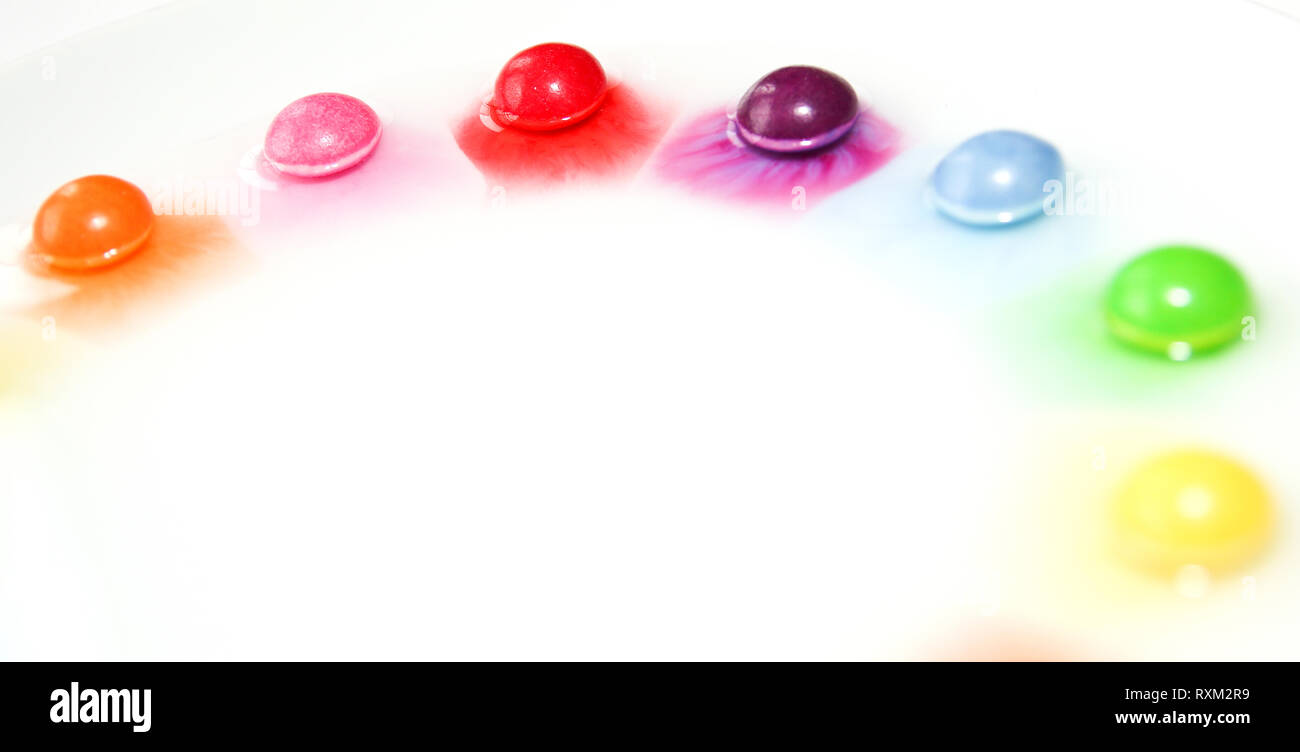 The candies are dissolving in the water and are making a colorful show ...