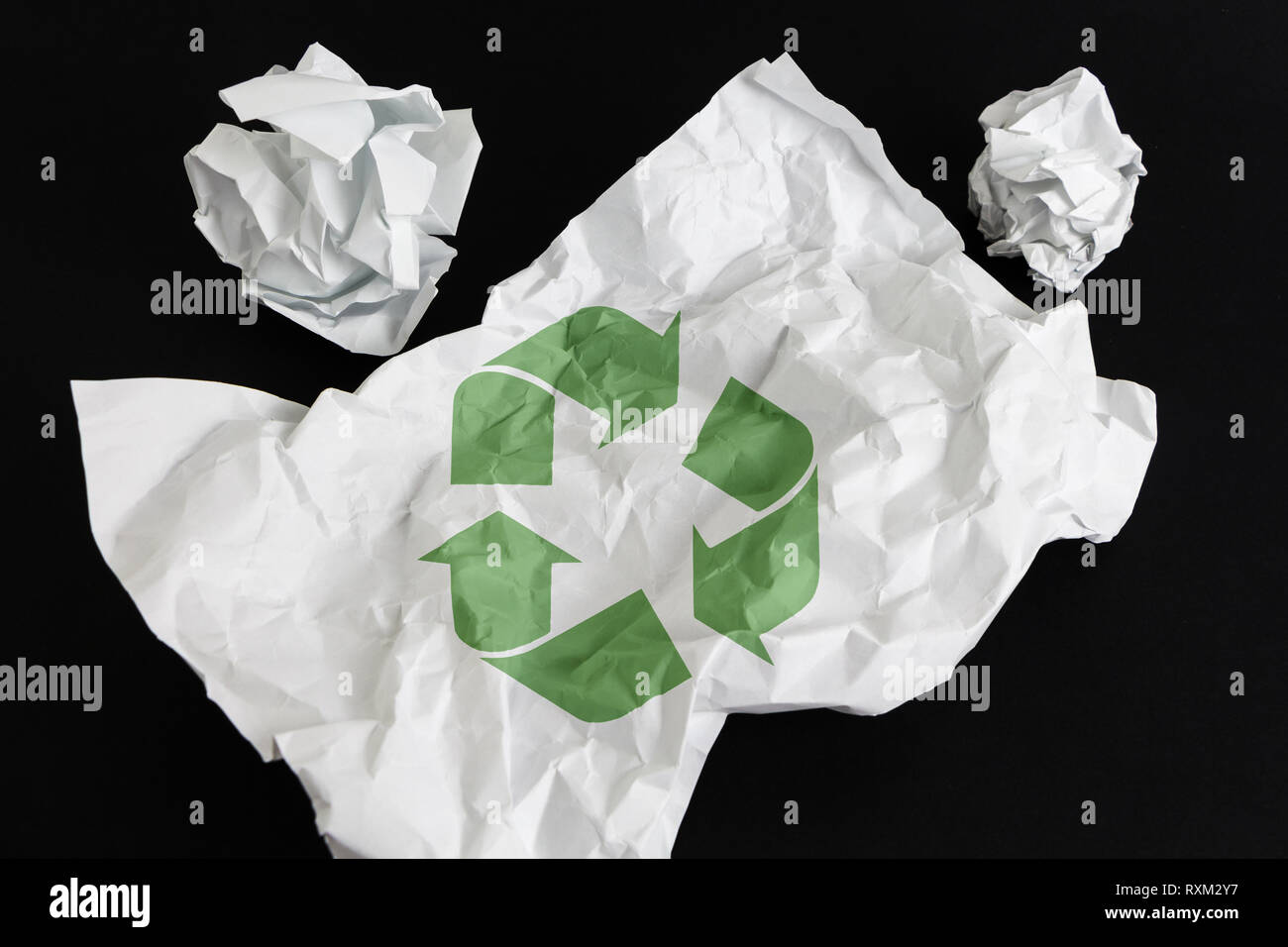 Crumpled paper sheet with Recycling Symbol isolated on black Stock ...