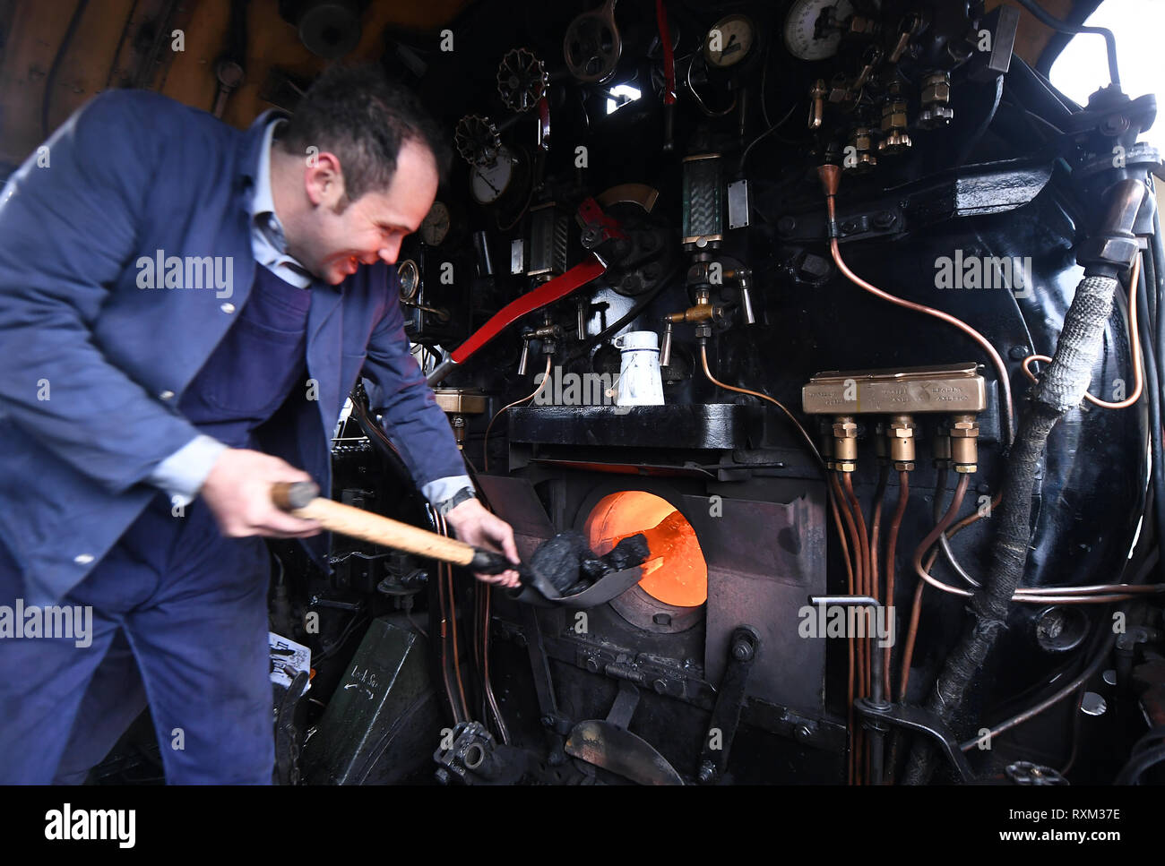 Coal is loaded into the firebox of steam locomotive 926 Repton during ...