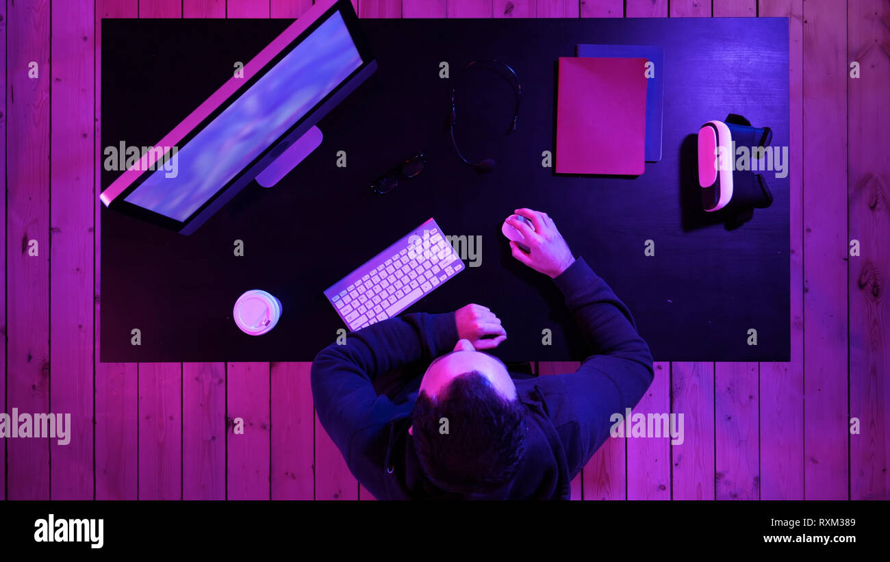 Joyful gamer guy playing video games on computer and showing thumb up ...