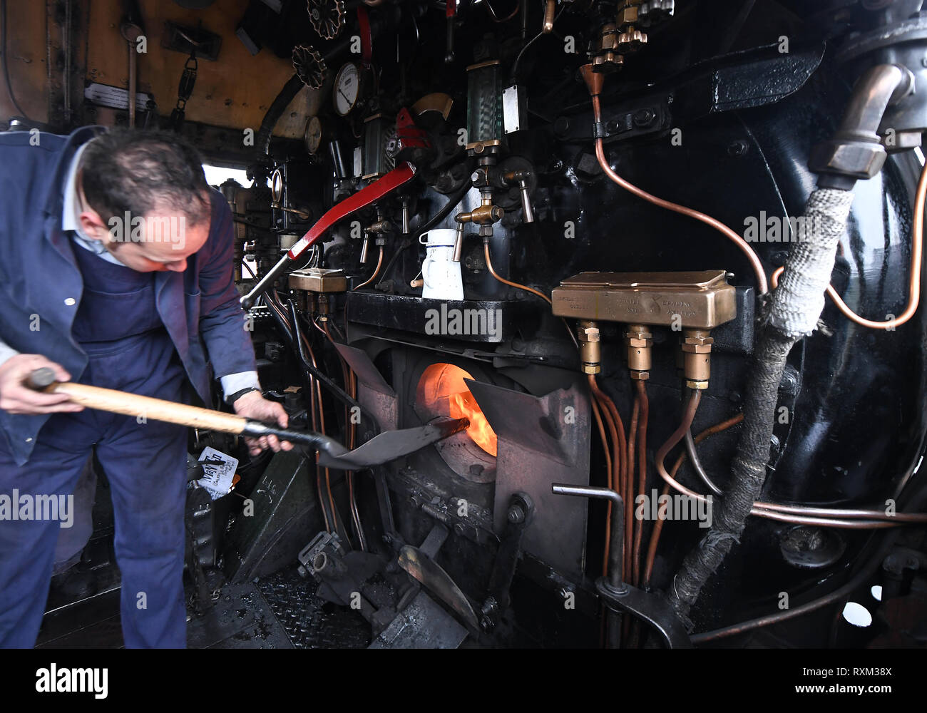 Coal is loaded into the firebox of steam locomotive 926 Repton during ...