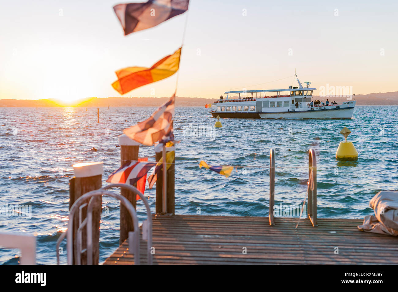 Sunset with red-yellow sun on a lake or sea. Sky, shore, sun and water ...