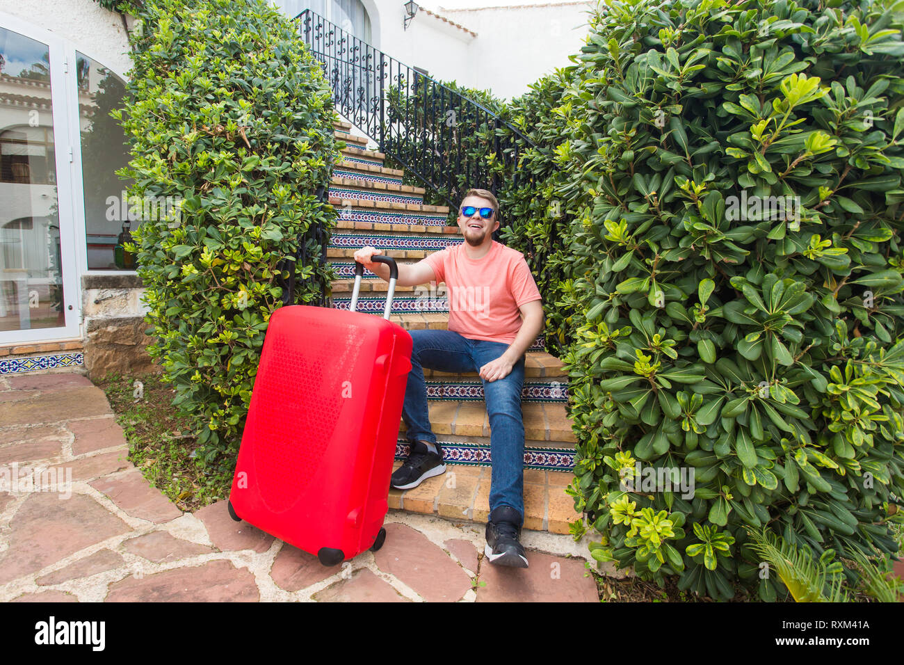 Travel, holiday and people concept - Happy handsome man tourist sitting ...