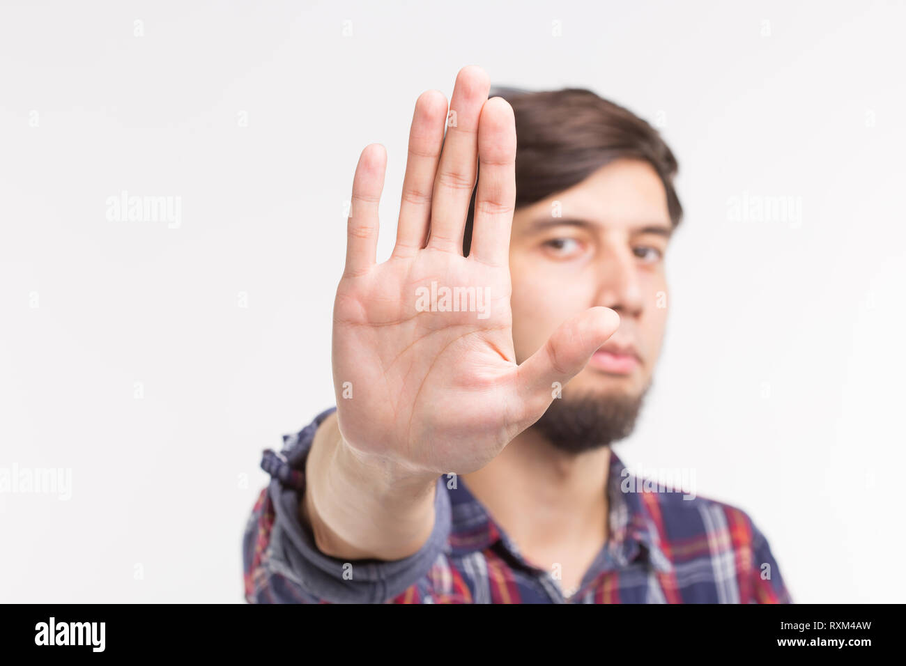 People, expression and gesture concept - young man showing stop gesture ...