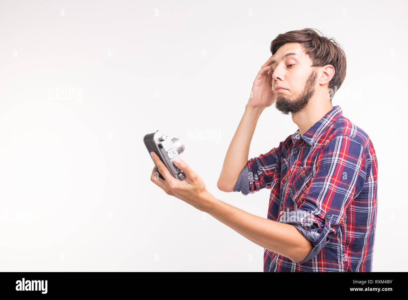 people, photo and gesture concept - man using an old fashioned camera ...
