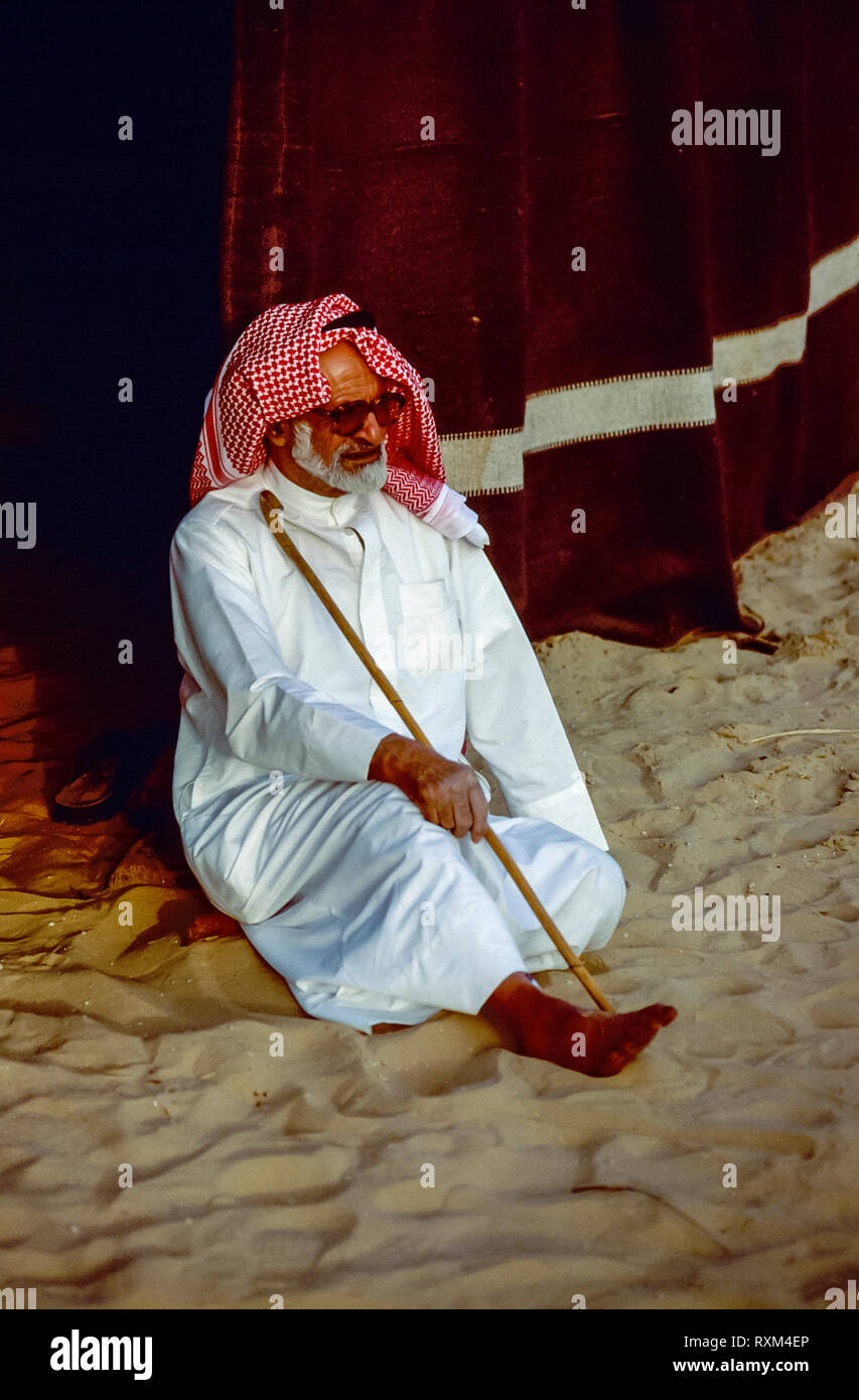 Arab folklore and history with elderly Emirati man resting and posing ...