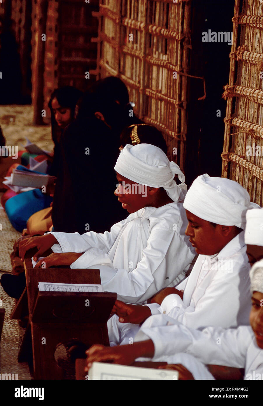 Arab folklore and history with young boys learning to recite the Koran ...