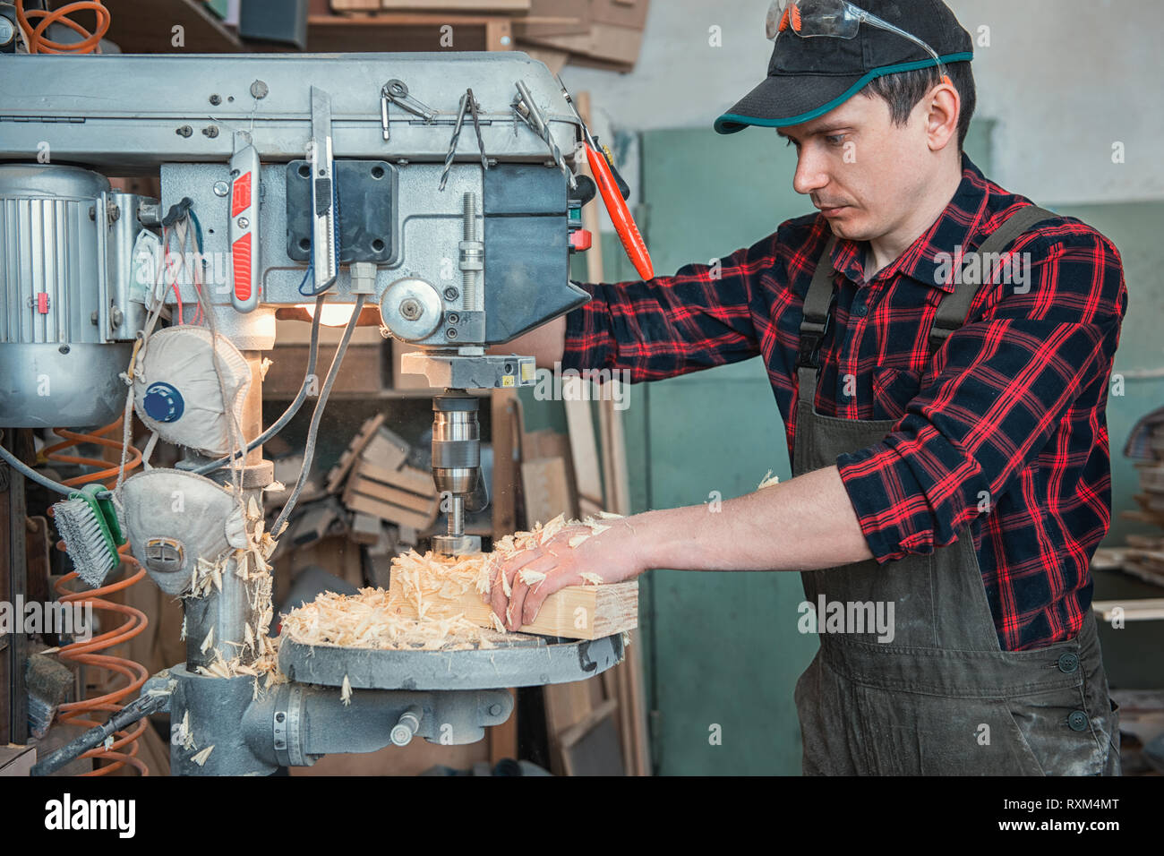 Carpenters with electric drill machine drilling wooden board Stock ...