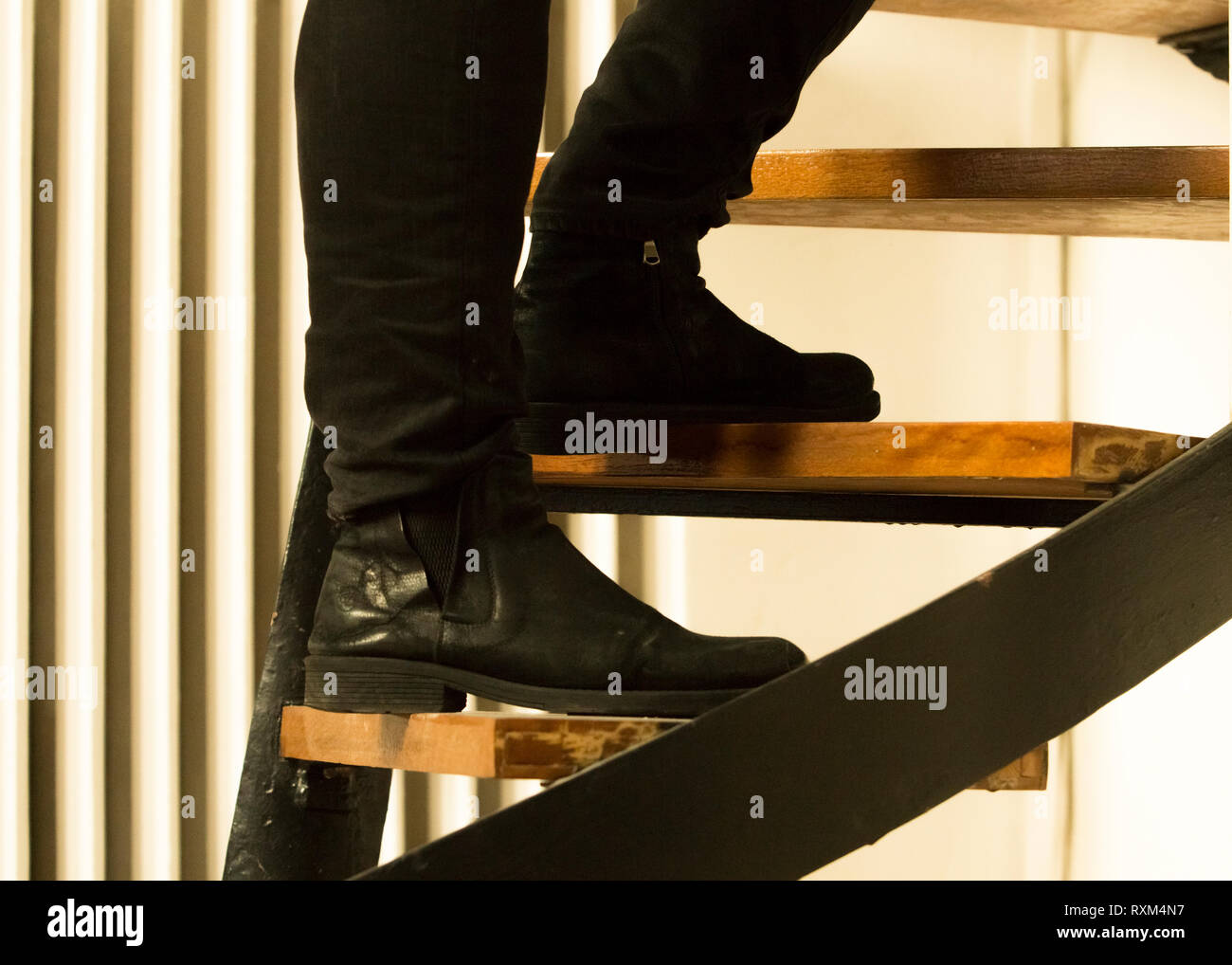 Three steps are seen where one foot of a male is just stepping on a ...