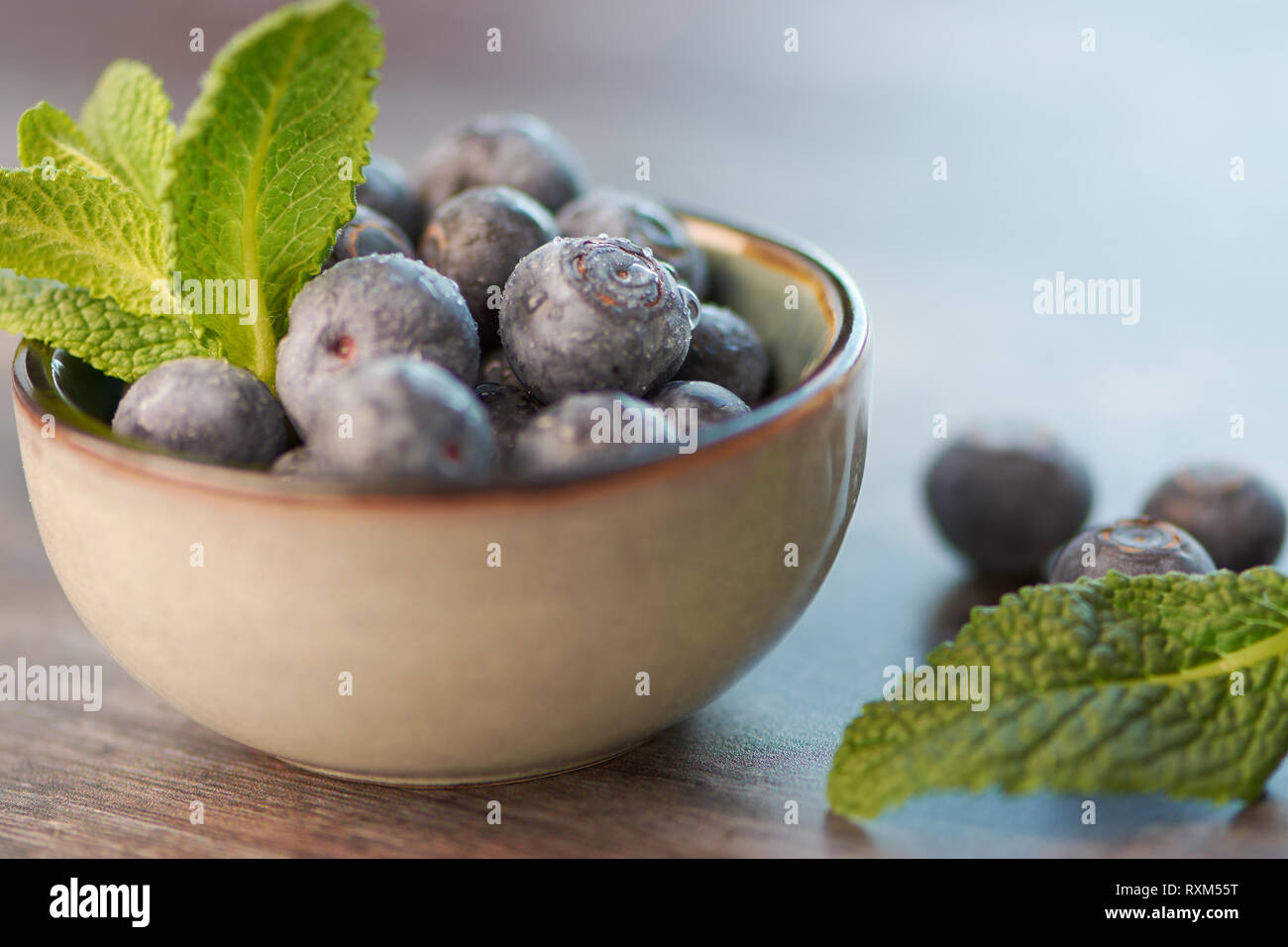 blueberries in a ceramic bowl on brown wooden background Stock Photo ...