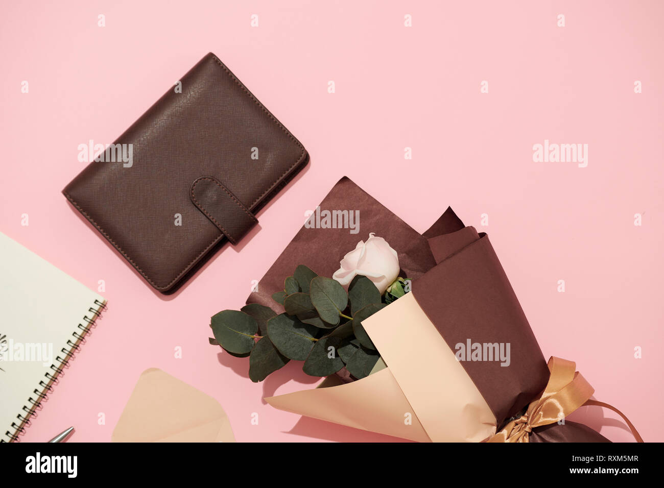 Office desk with notebook, beautiful bouquet of roses on pink Stock ...