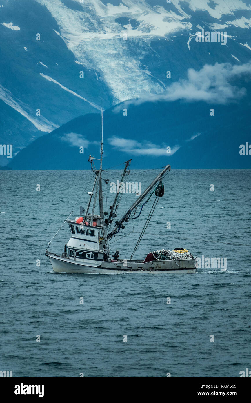 Sailboat in front of glacier under the clouds, Alaska Stock Photo - Alamy
