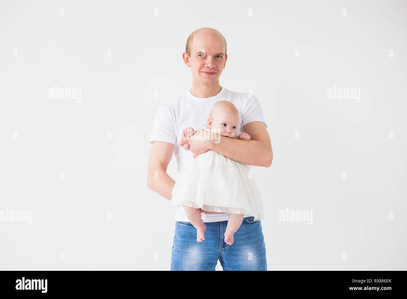 family, fatherhood and children concept - bald father holding cute ...