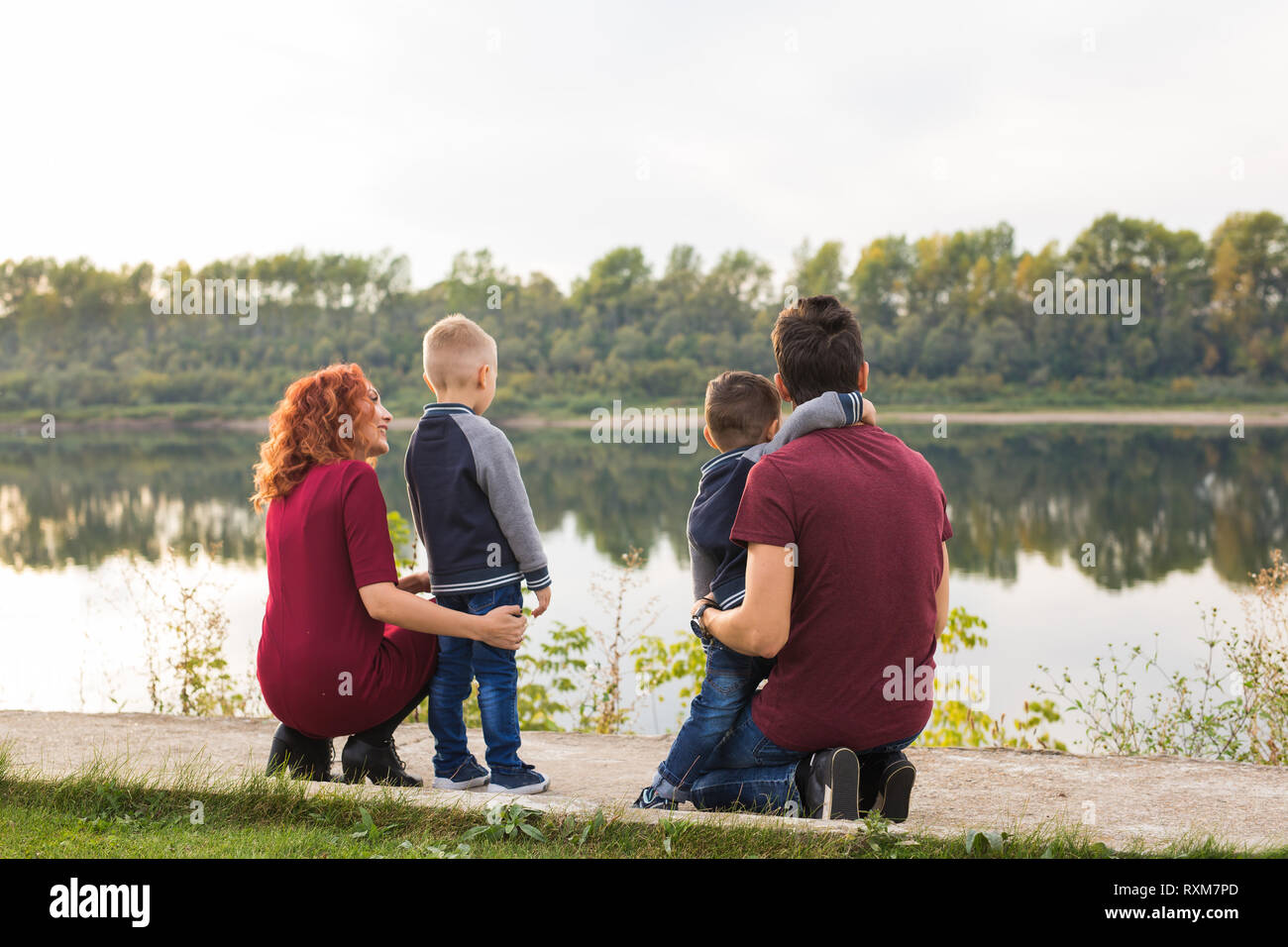 Parenthood, childhood and family concept - Parents and two male ...