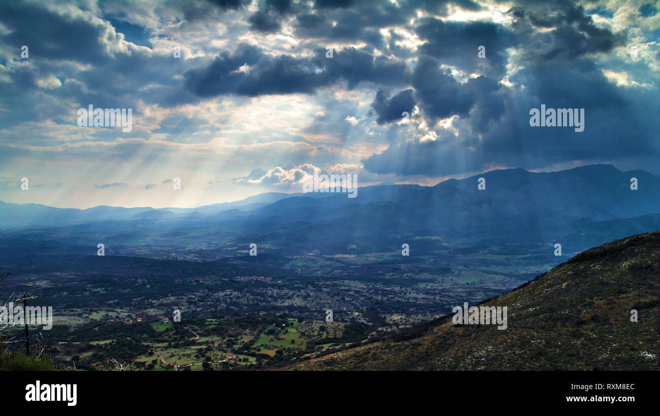 Sun rays through the clouds mountains and valley , in Arcadia Greece ...