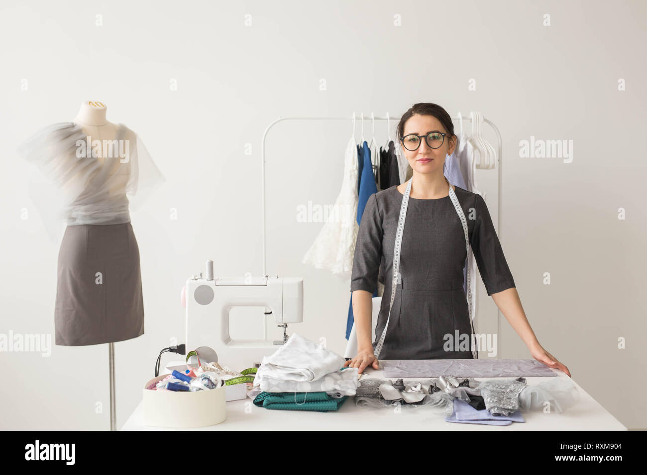 Dressmaker, fashion designer and tailor concept - Young dressmaker ...
