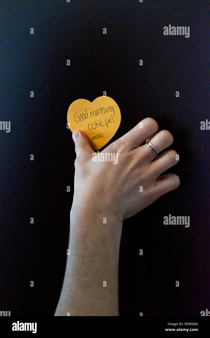 Generic loving note being stuck to refrigerator Stock Photo - Alamy