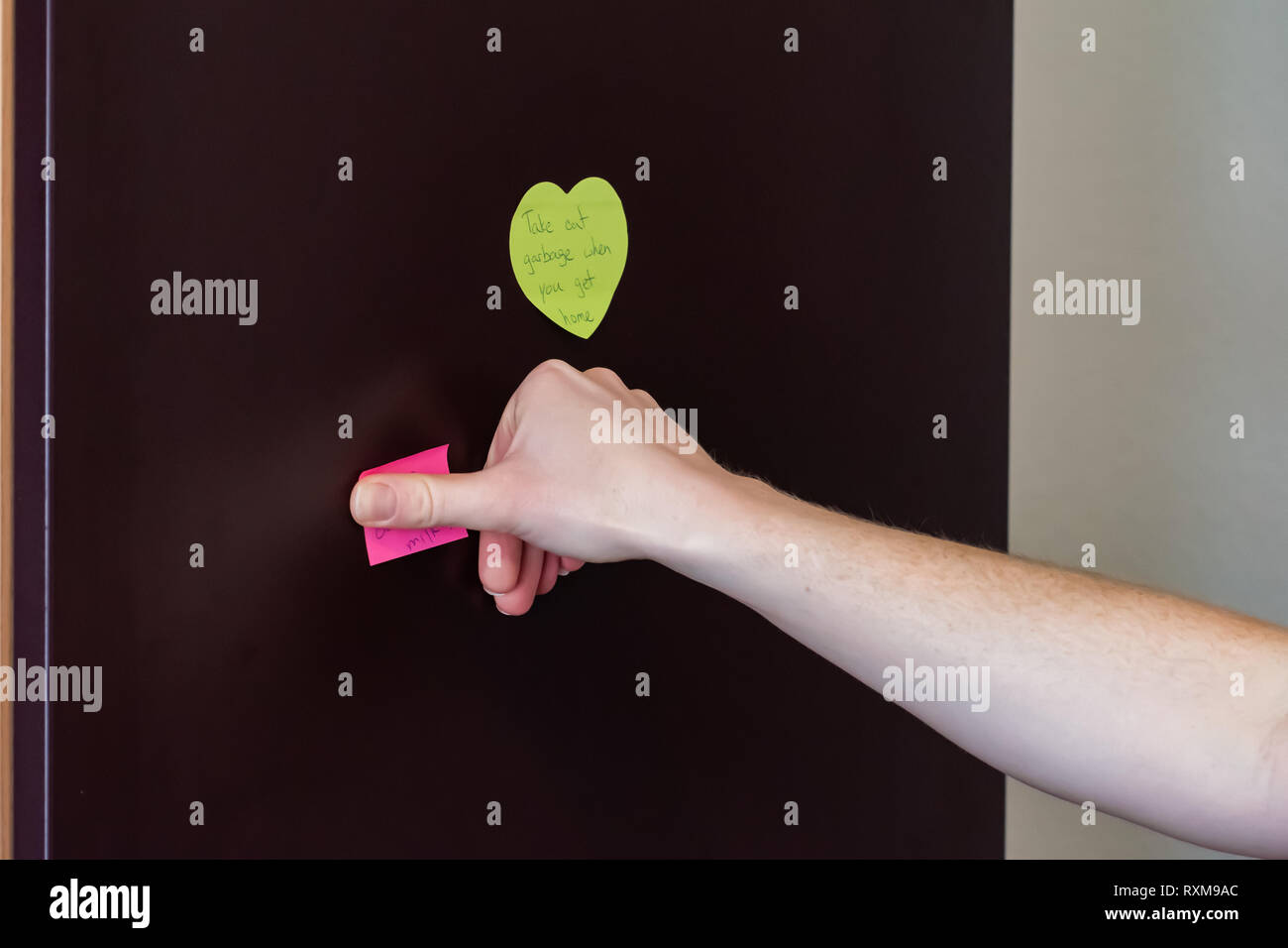 Close-up side view of generical sticky notes getting placed on the ...