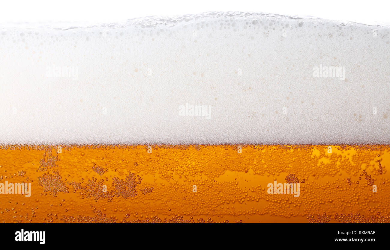 Close up background texture of lager beer with bubbles and froth in ...