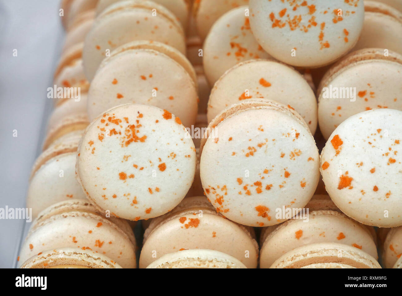 Fresh baked white and beige macaroon pastry cookies (macarons, macaroni ...